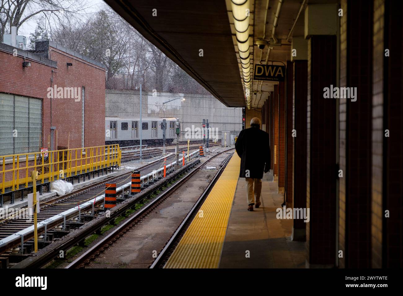 A man is walking on a subway platform in midtown Toronto. He is going ...