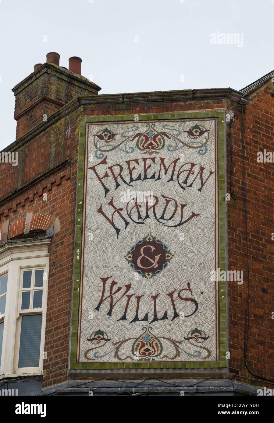 Advertising sign for Freeman Hardy & Willis shoe retailer on building ...