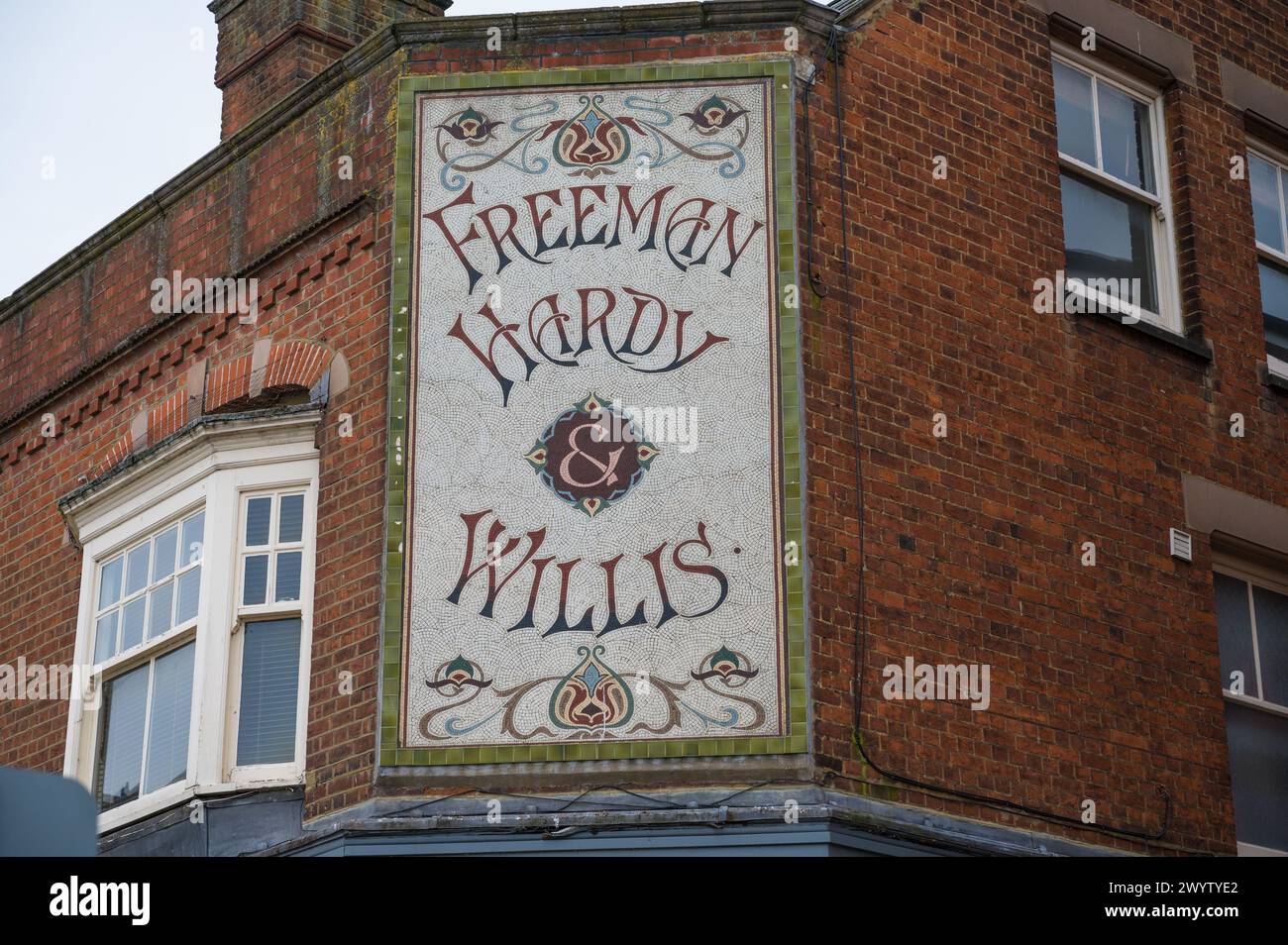 Advertising sign for Freeman Hardy & Willis shoe retailer on building ...