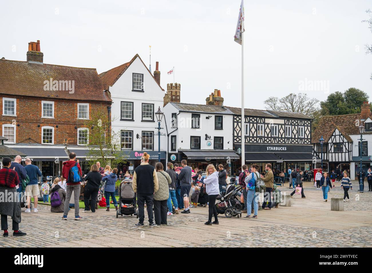 Small crowd of people gathered to watch a street entertainer in Market ...