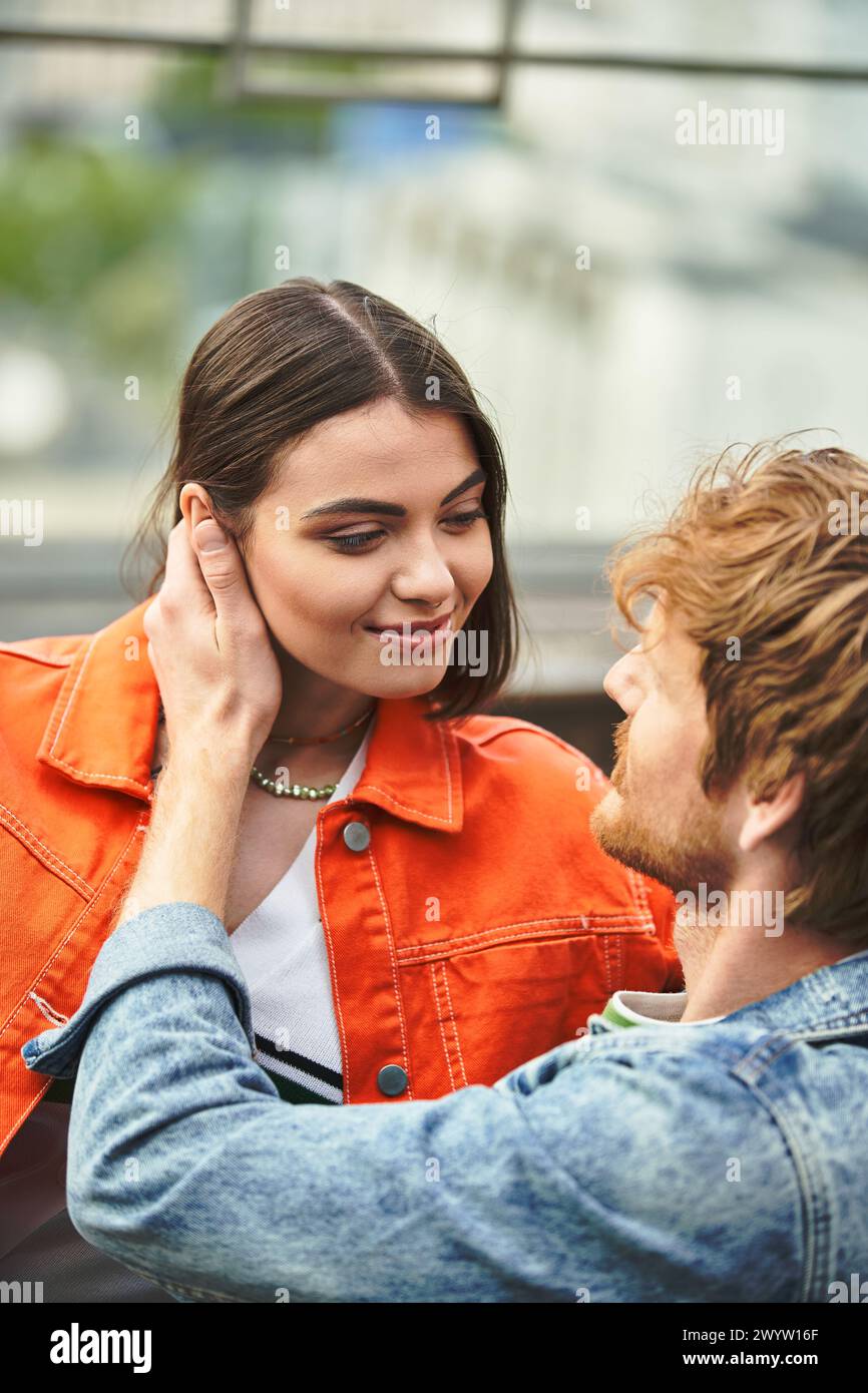 A man and a woman stand side by side, exuding a sense of closeness and ...