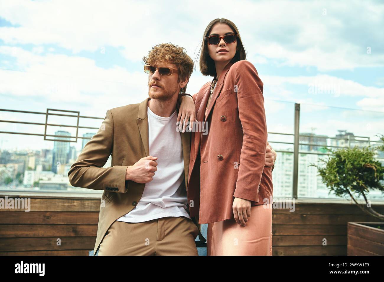 A man and a woman stand side by side, gazing into the horizon, their ...