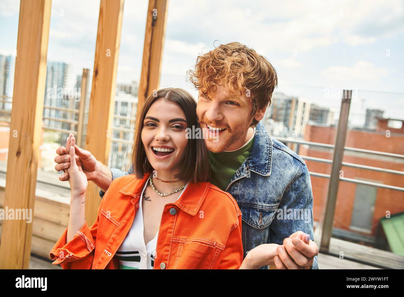 A man and a woman standing side by side, their bodies slightly turned ...