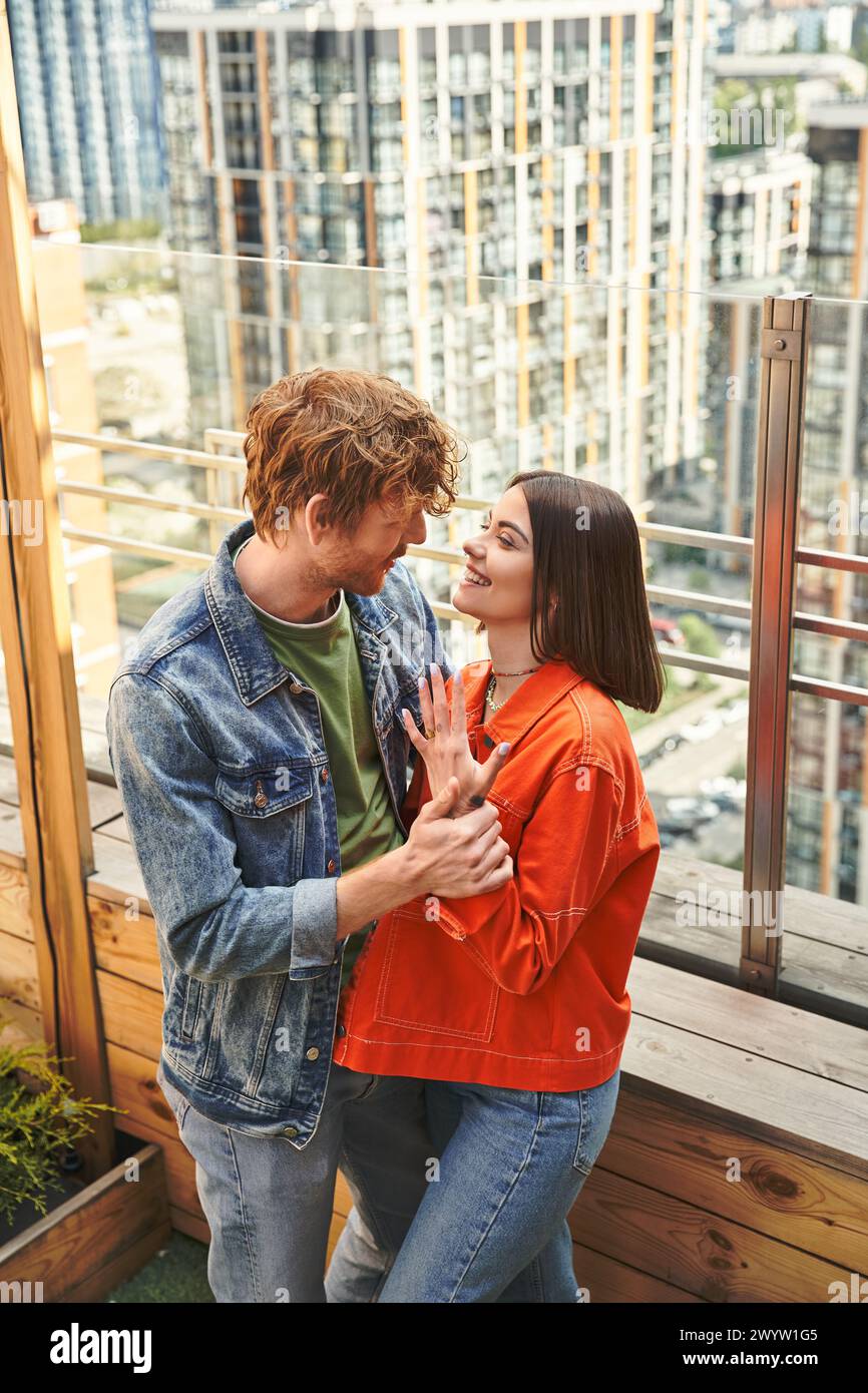 A man and woman are standing in close proximity, exuding a sense of ...