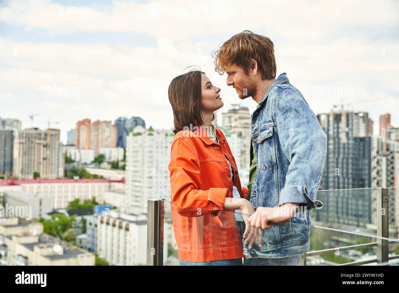 A man and a woman standing close together, sharing a moment of ...