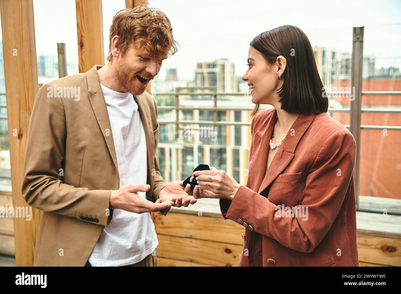 A man and a woman stand side by side, their arms around each other ...