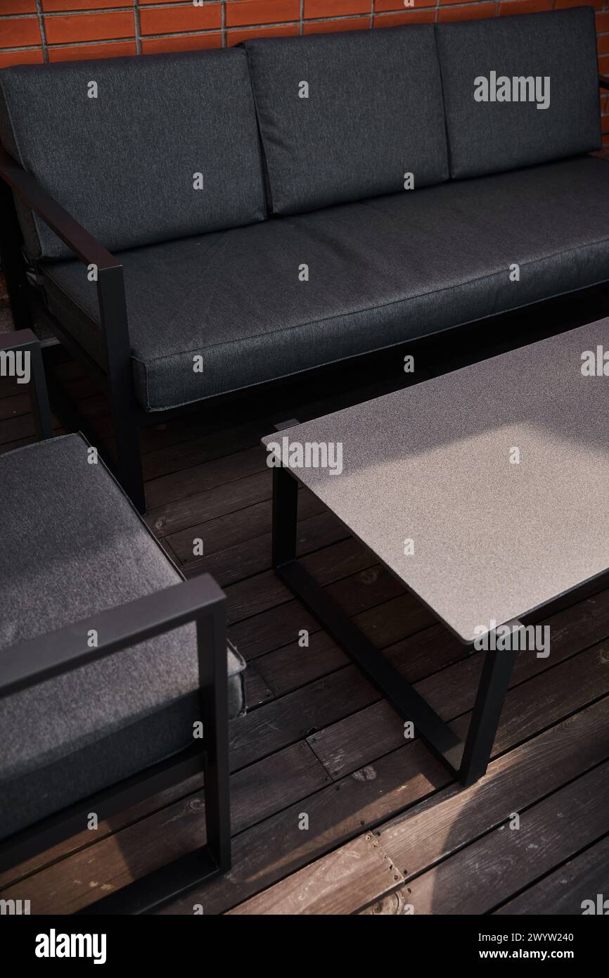 A stylish couch and modern table furniture set on a weathered wooden ...