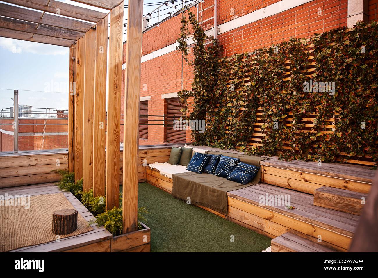 A stylish couch sits elevated on top of a sturdy wooden bench, creating ...
