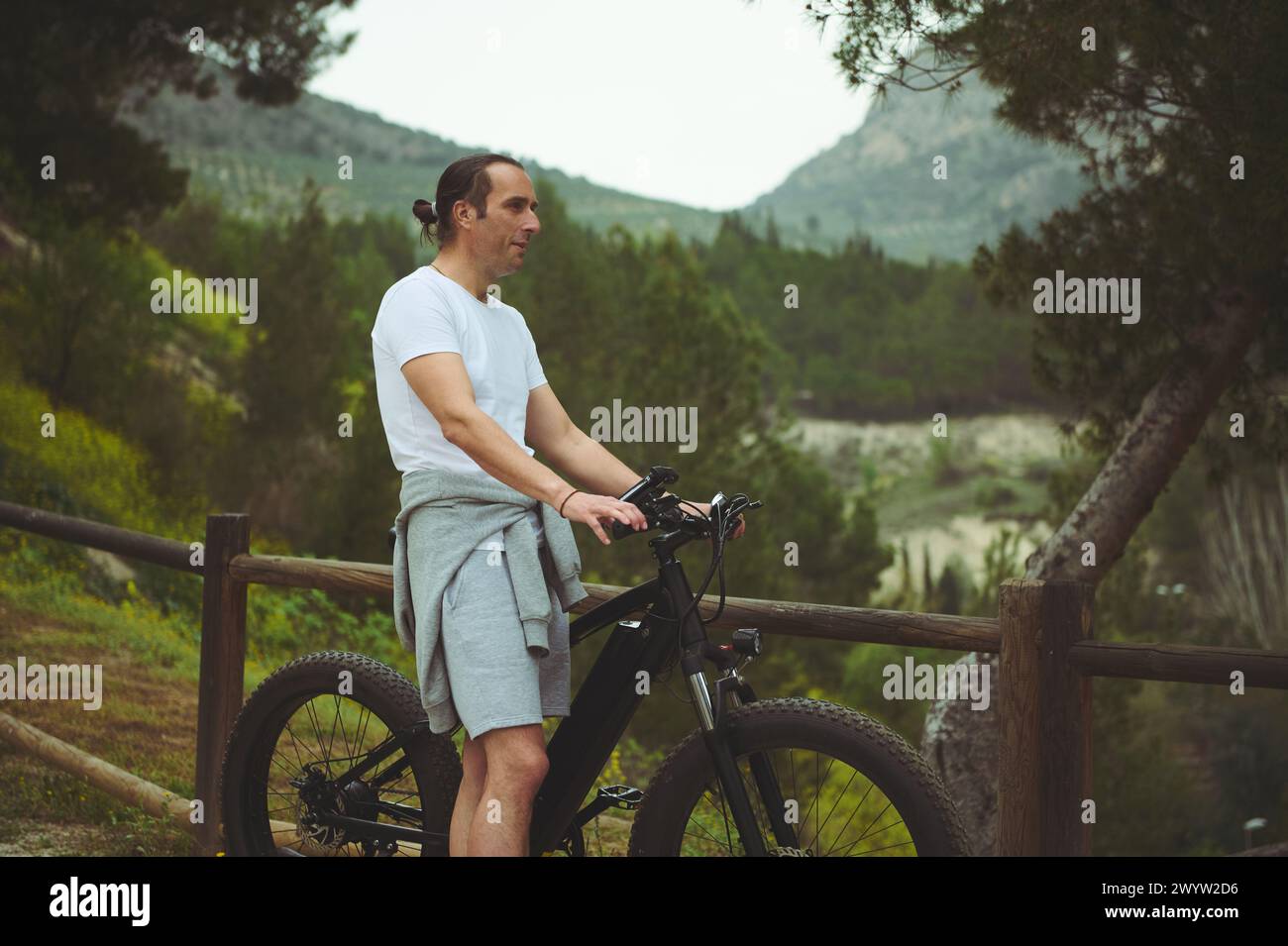 Portrait of Caucasian young athletic man using electric bike, motor ...