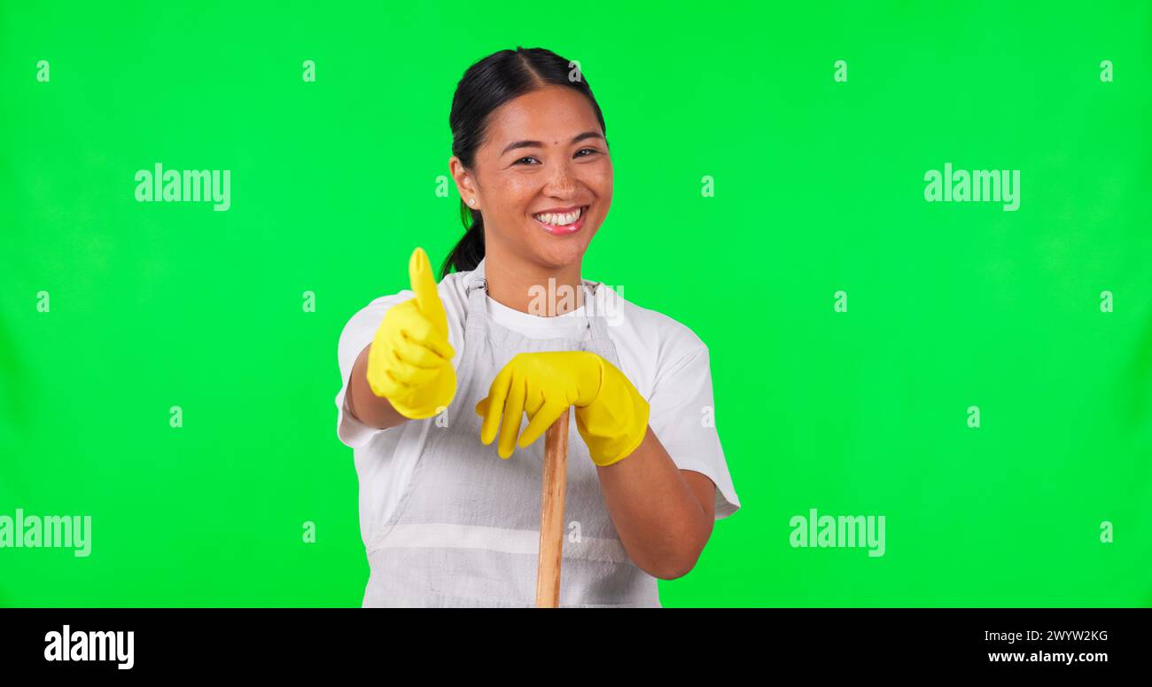 Happy asian woman, housekeeper and thumbs up on green screen for clean ...