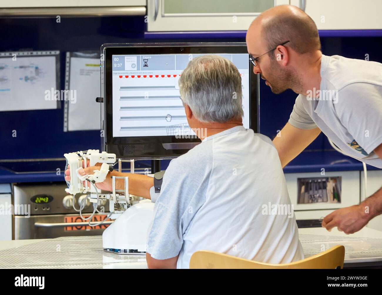 Investigator and patient with assistive robot for upper limb ...