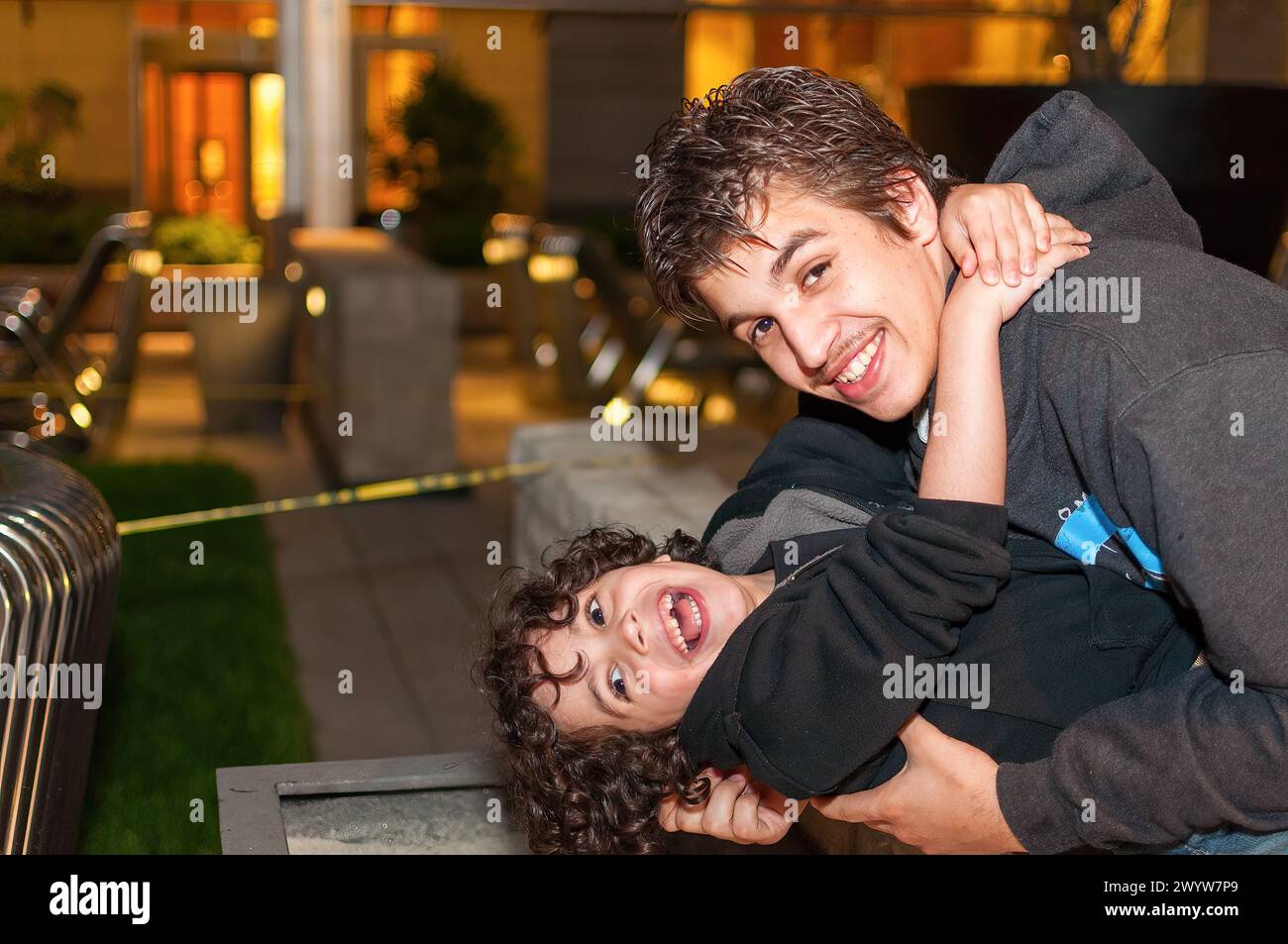 portrait of latin american siblings, two male children kids playing ...