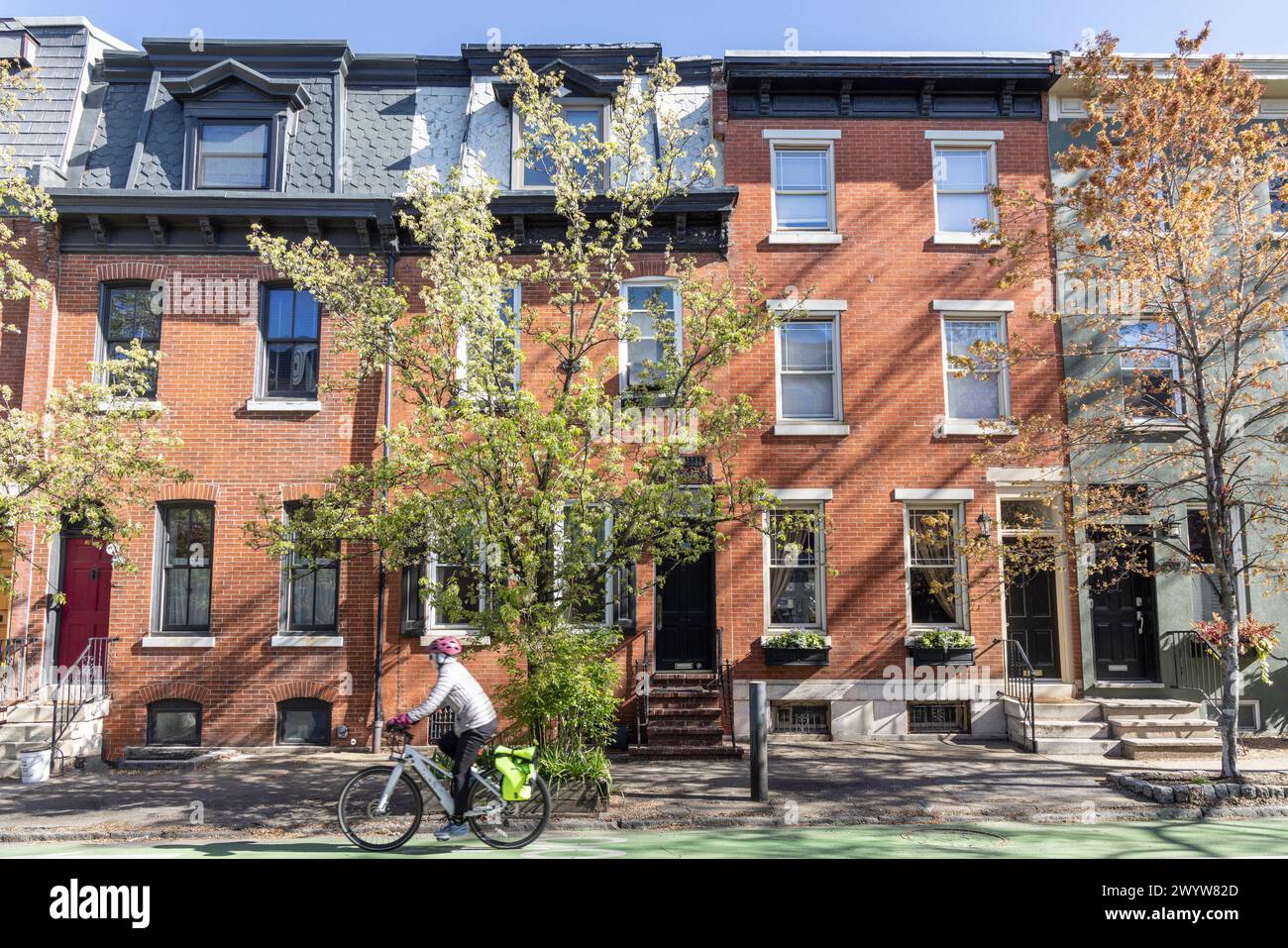 Cyclist in front of row homes, Fitlers Square neighborhood ...