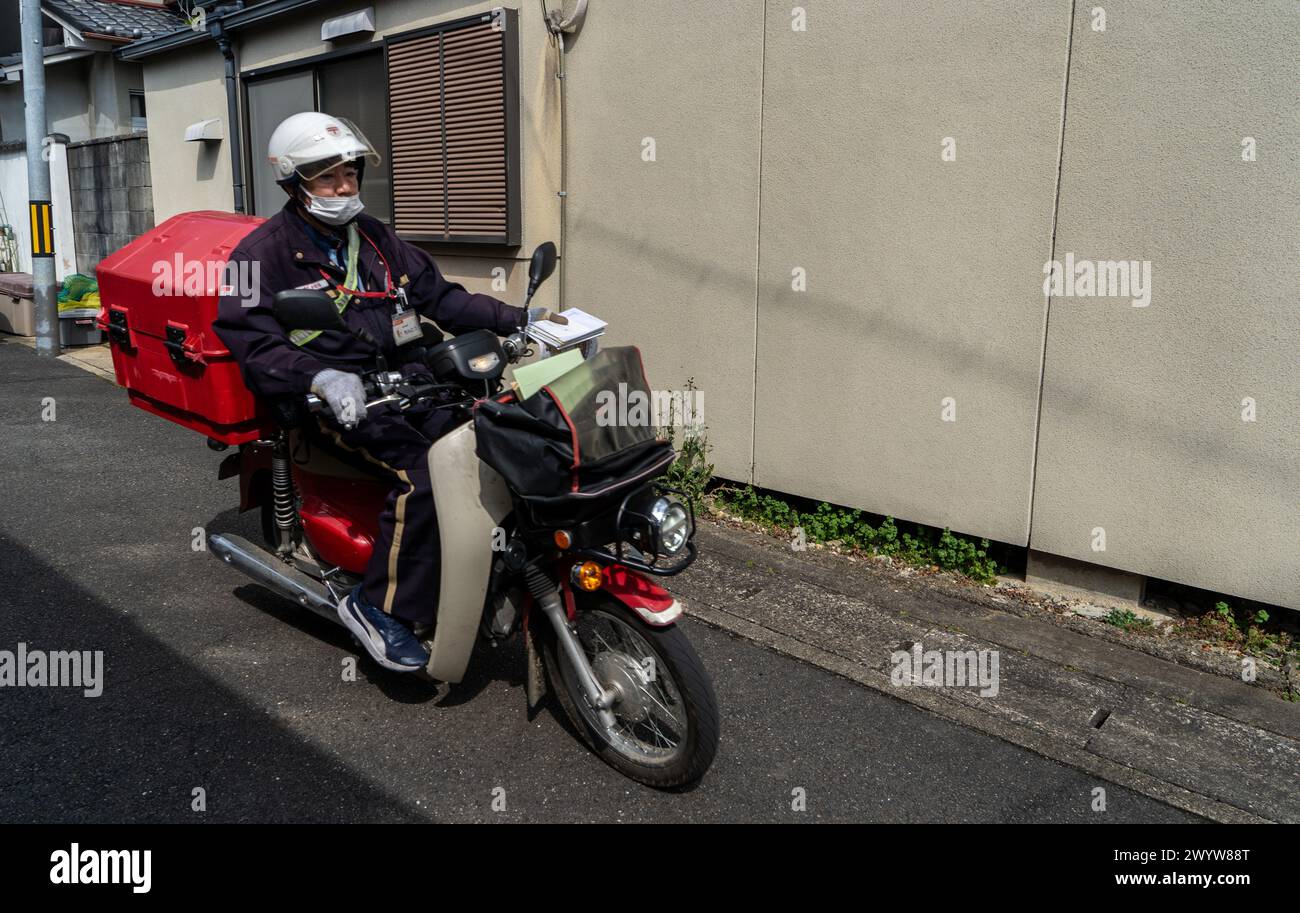 Post office delivery man on motorbike in Kyoto,Japan Stock Photo - Alamy