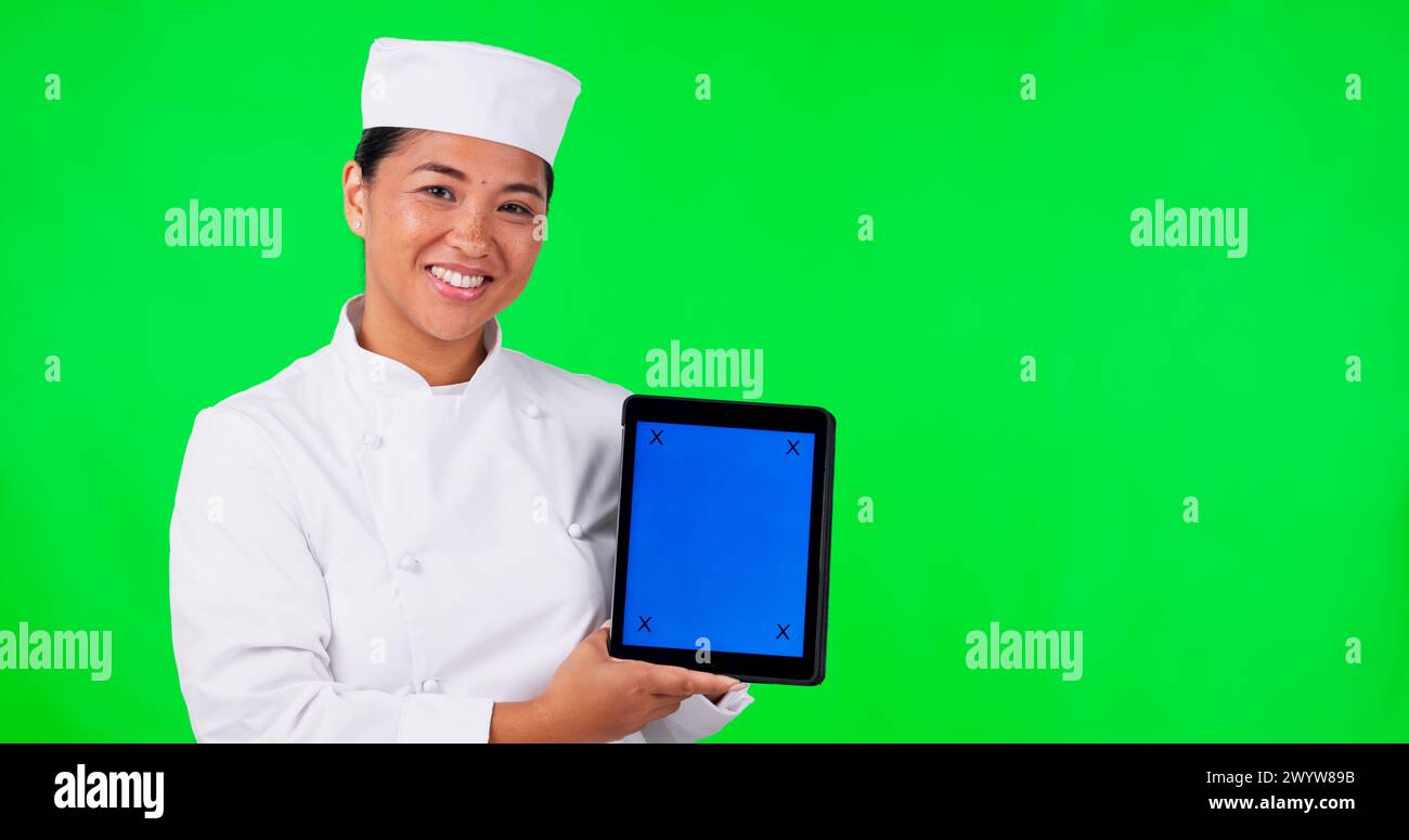 Tablet, cooking and a woman chef on green screen background in studio ...