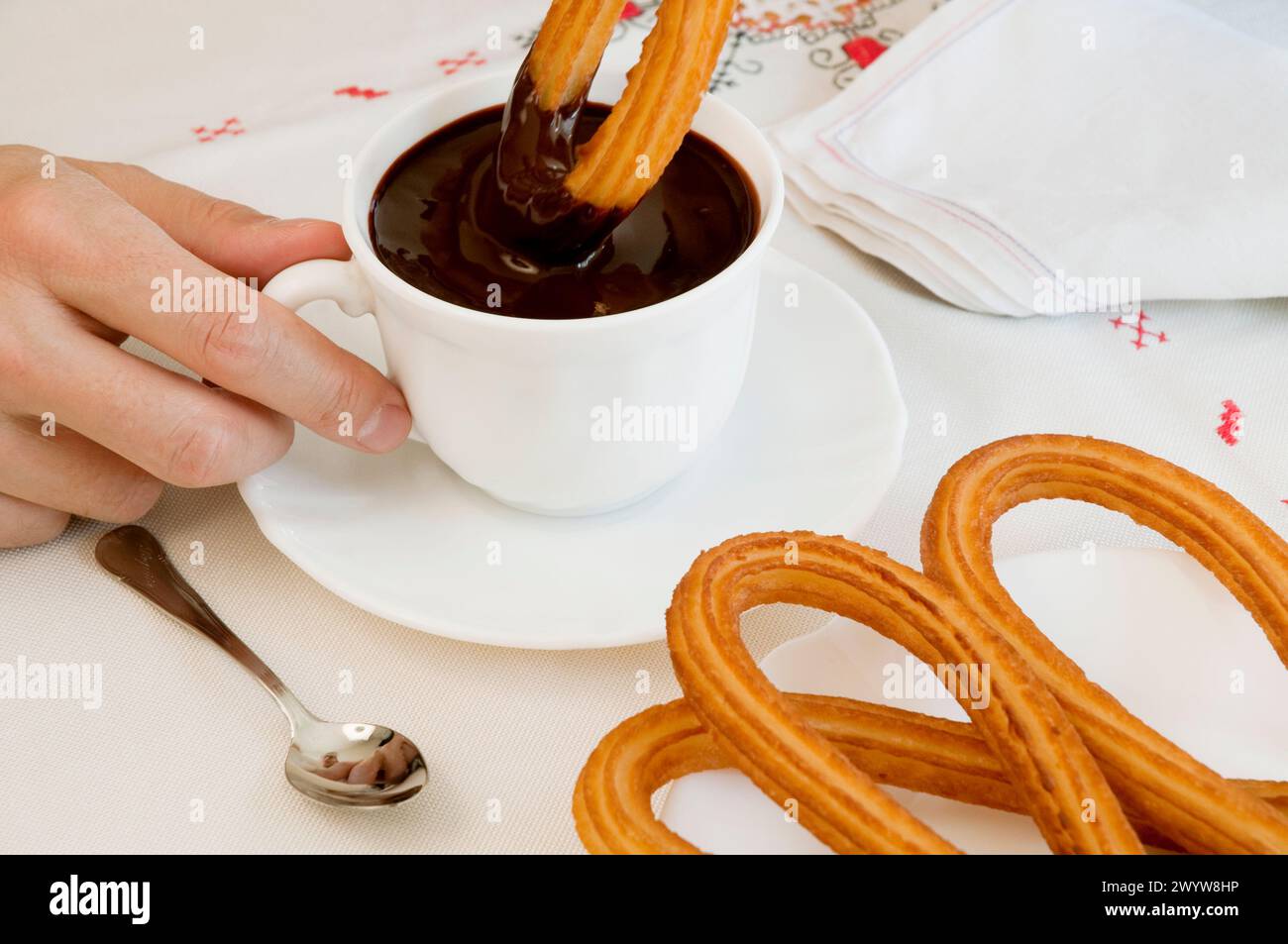 Man having chocolate with churros. Close view Stock Photo - Alamy