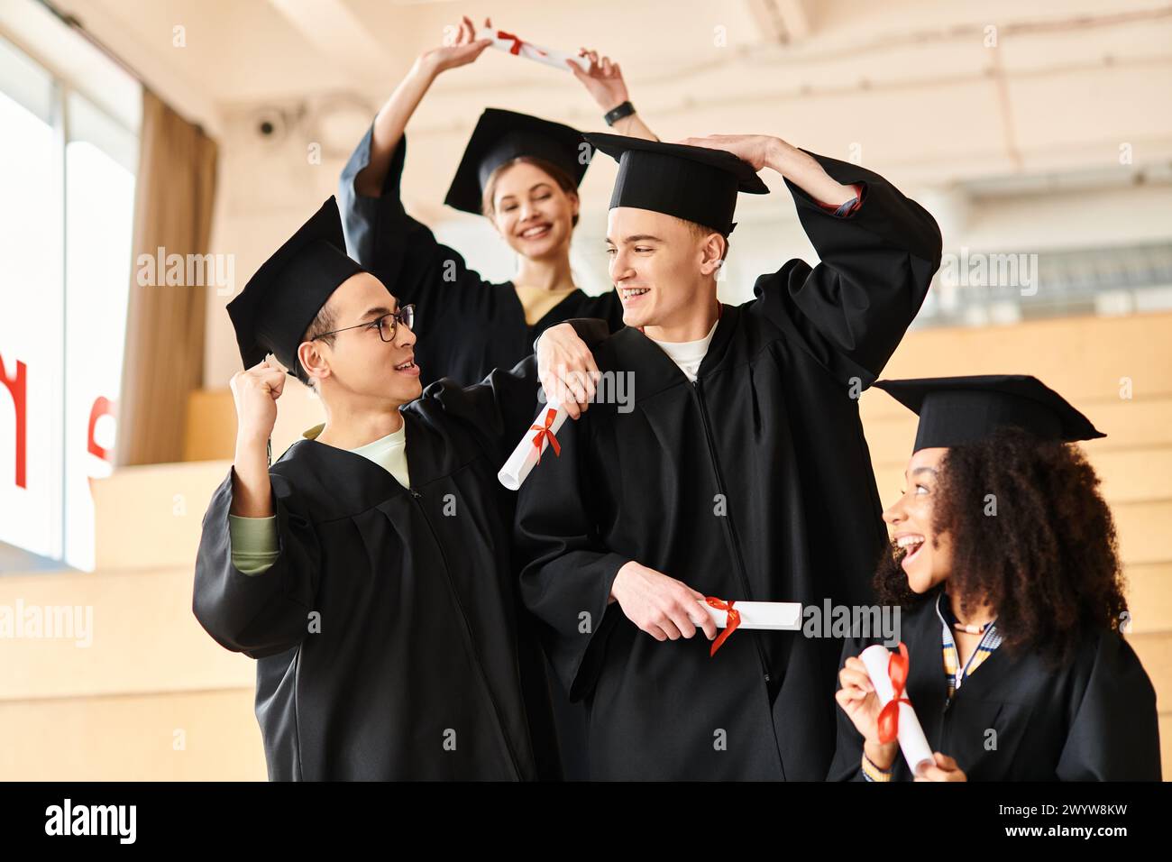 A group of young students from various ethnic backgrounds celebrating ...