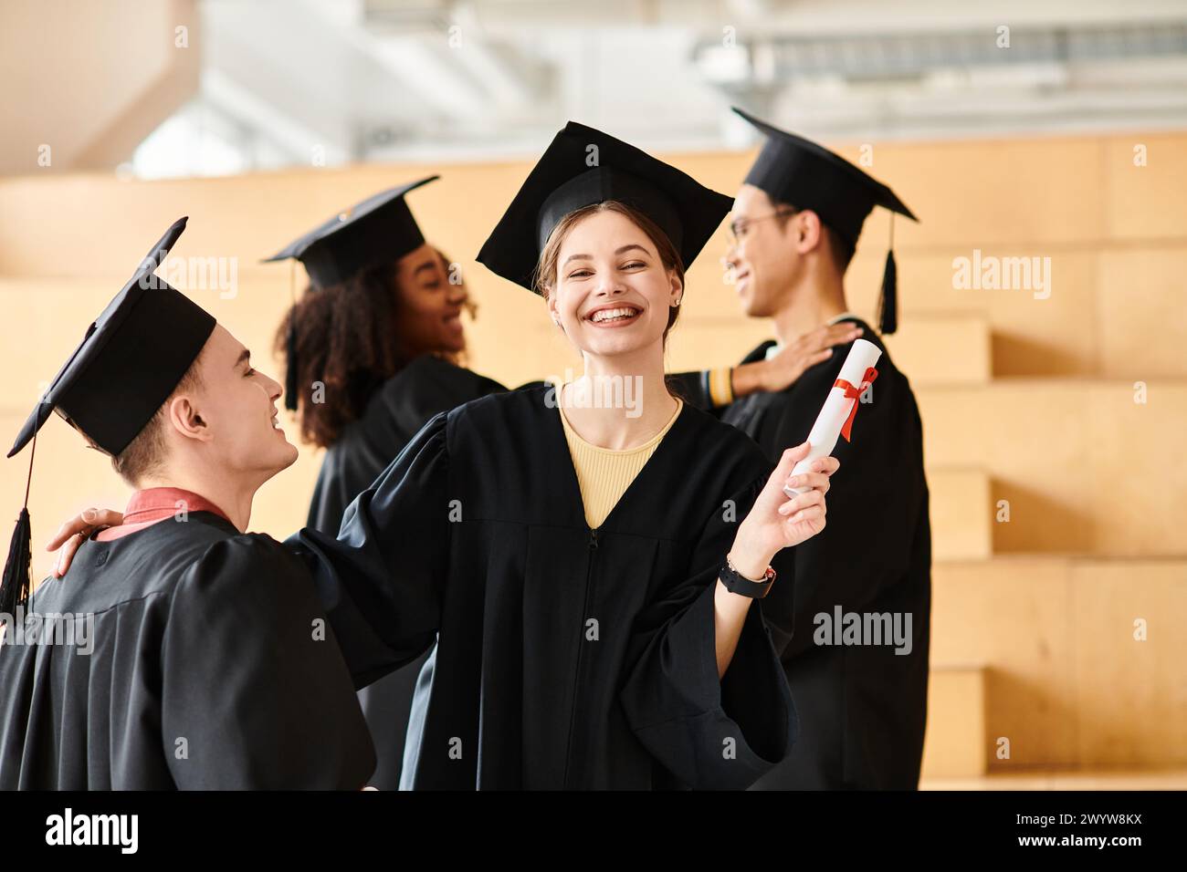 A diverse group of students in graduation gowns and caps celebrating ...
