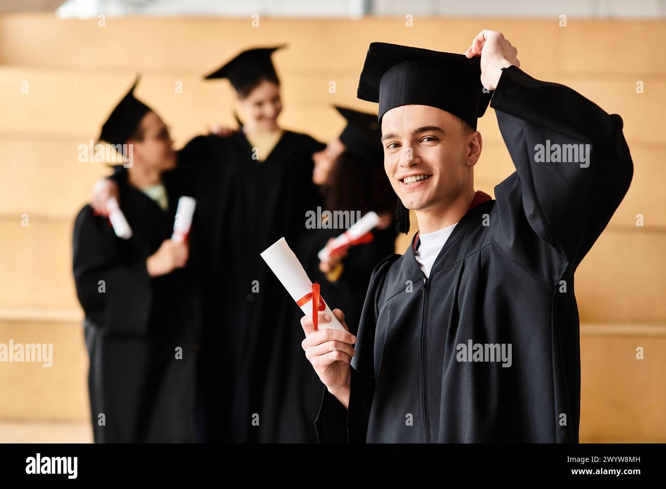 A diverse group of happy students celebrating graduation. A man in a ...
