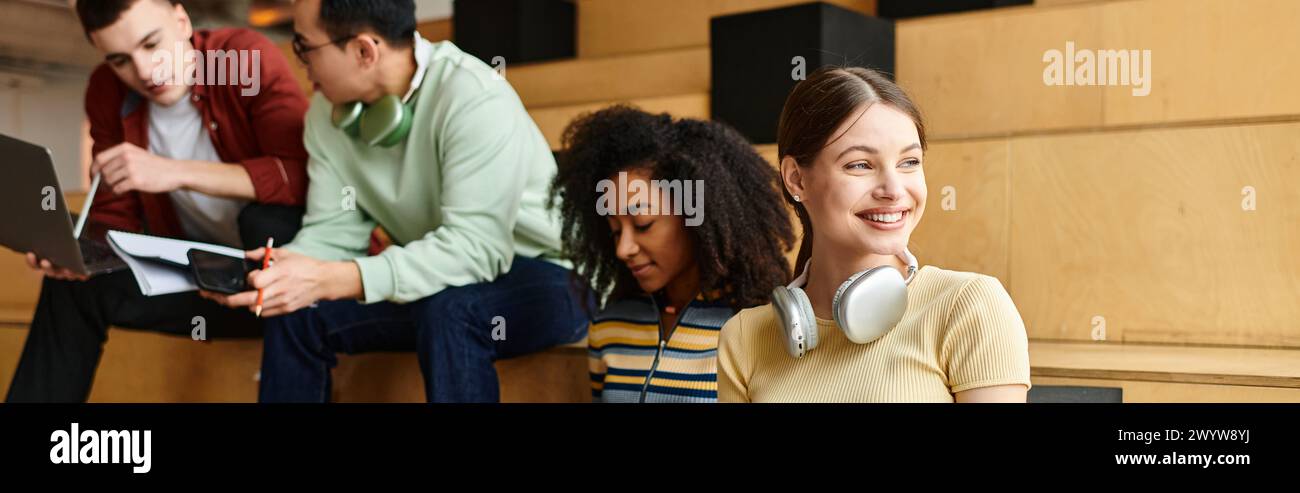 A diverse group of students from different backgrounds sitting together ...