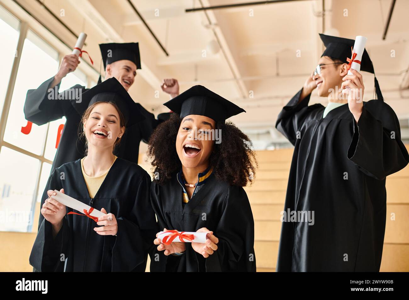 Multicultural group of students celebrating their graduation in ...