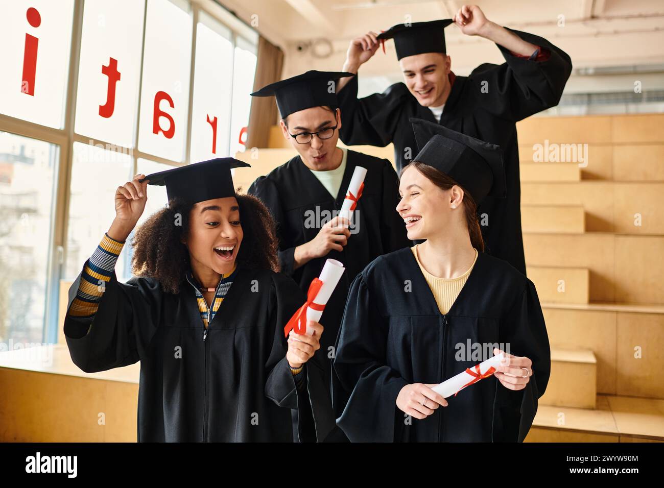 A diverse group of students in graduation gowns and mortarboards ...