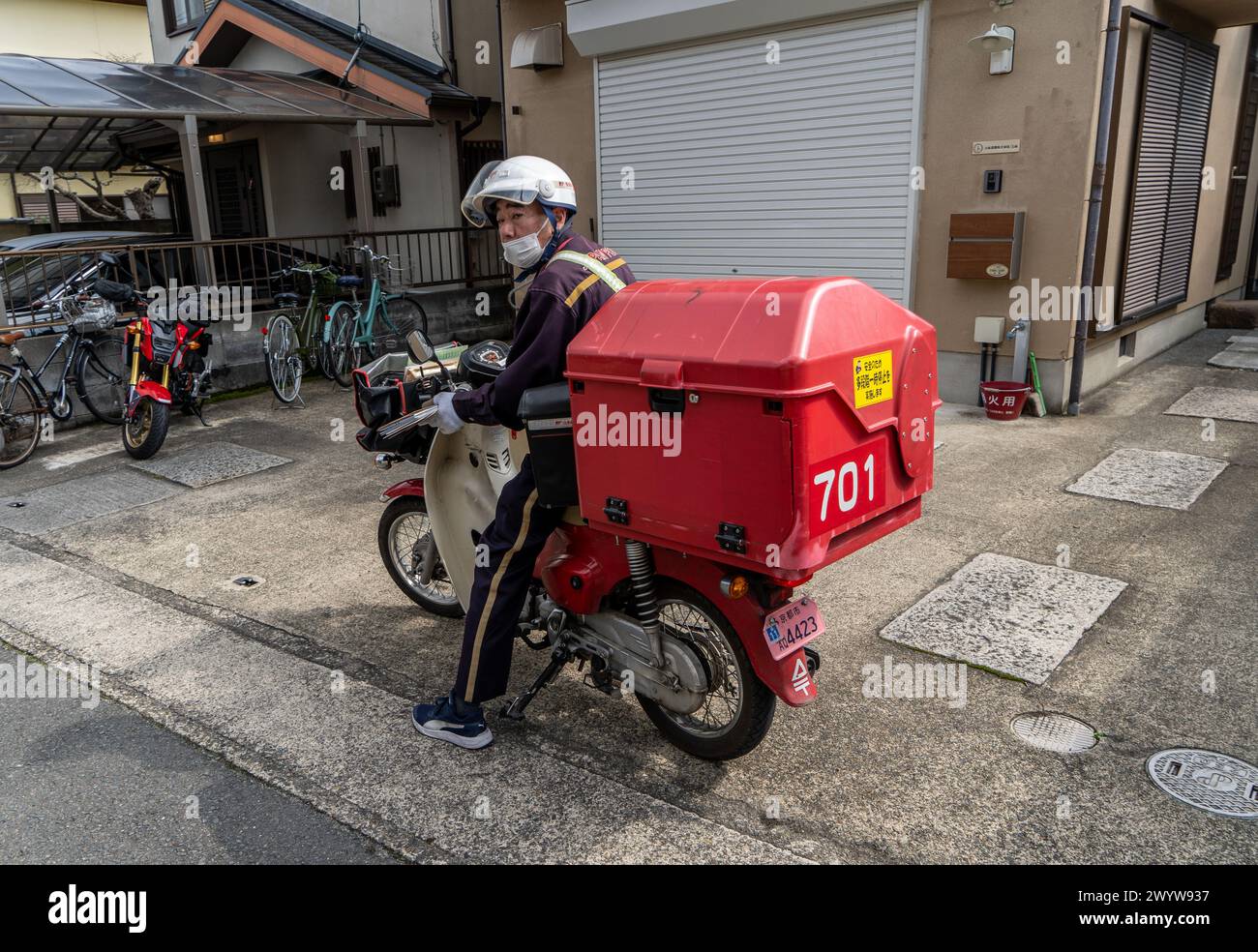 Post office delivery man on motorbike in Kyoto,Japan Stock Photo - Alamy