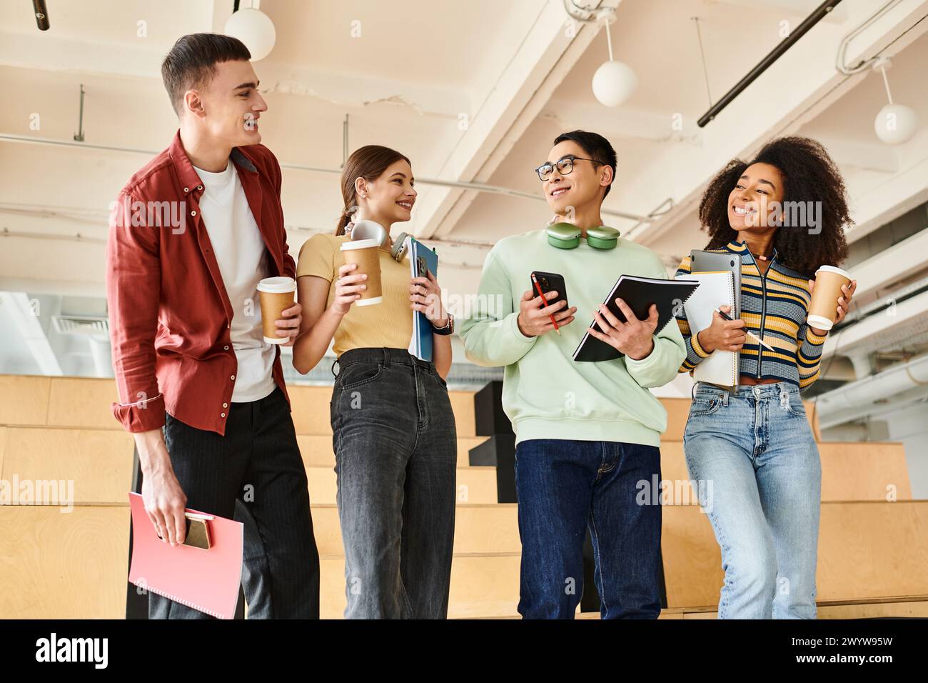 A group of young people from different backgrounds stand together ...