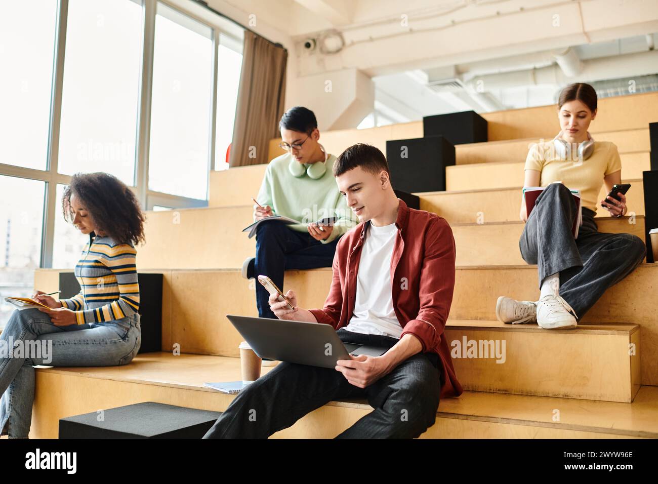 Multicultural group of students socializing and studying together on a ...