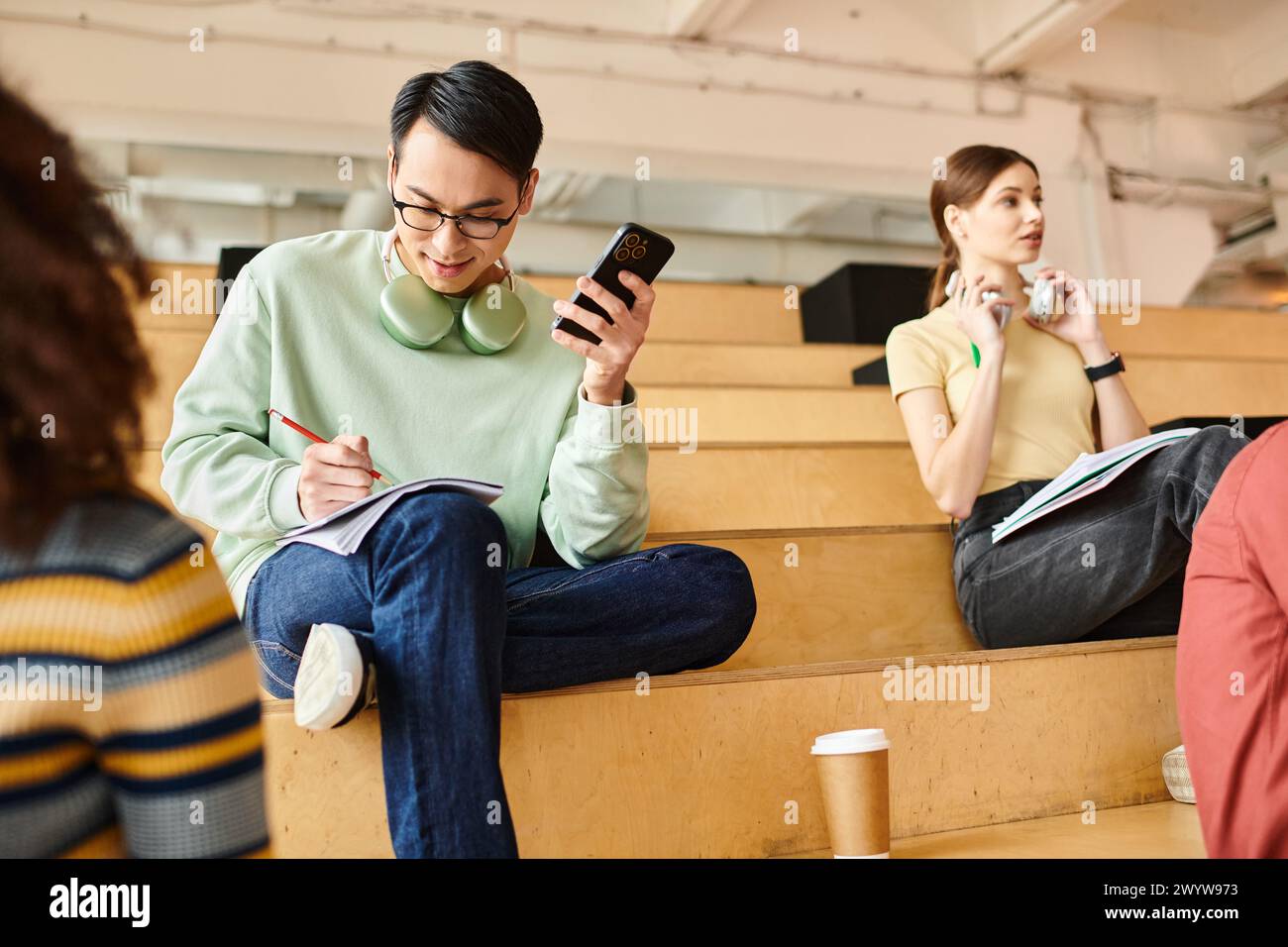 A multicultural group of students attentively listening in a lecture ...