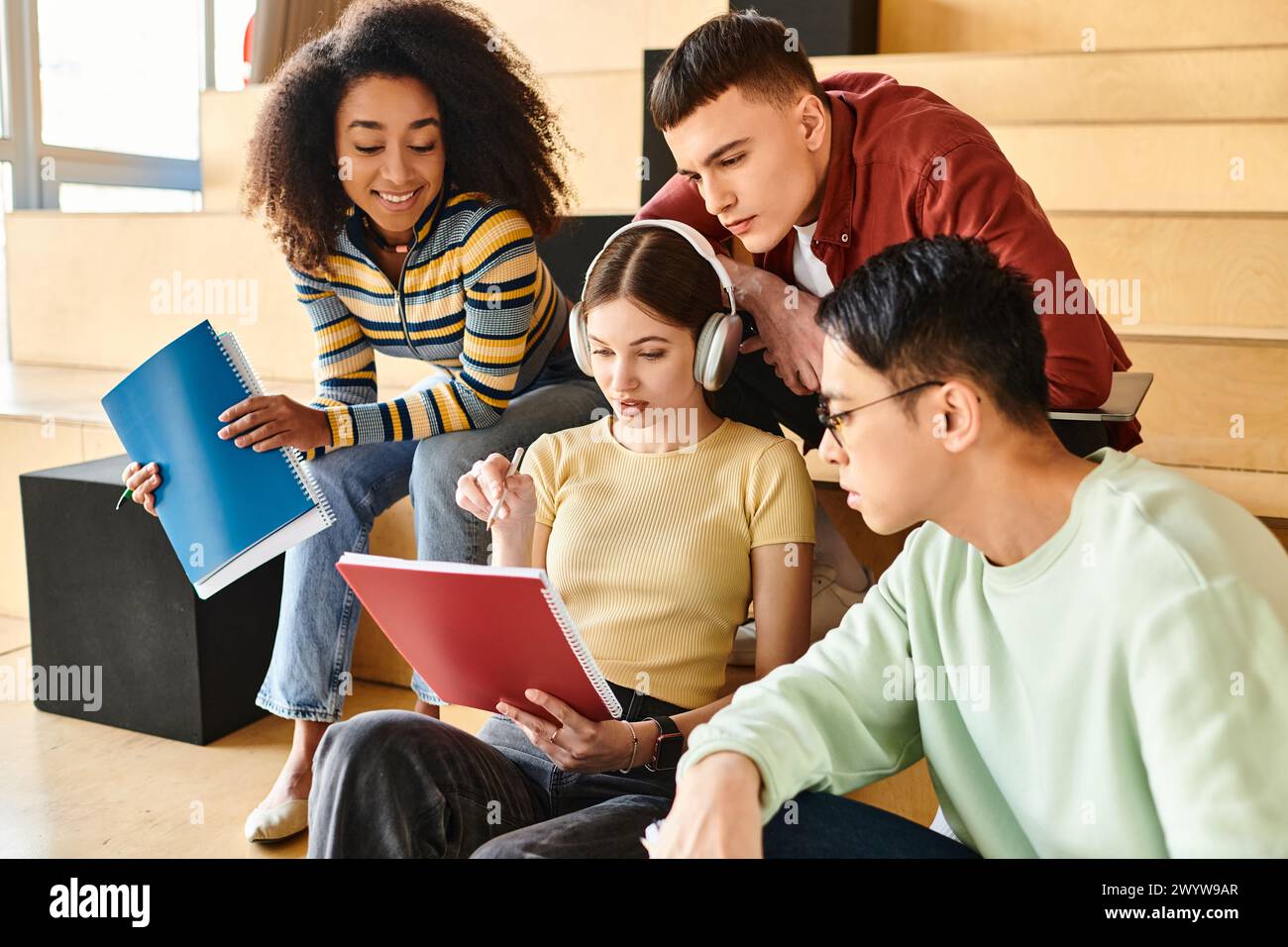 Multicultural group of students sit on the floor, sharing stories and ...