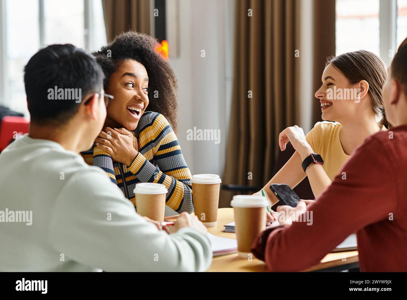 A diverse group of students engaging in a lively discussion around a ...