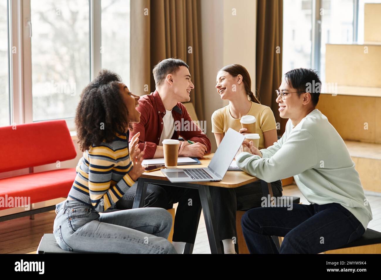 A diverse group of students from different ethnic backgrounds engaging ...