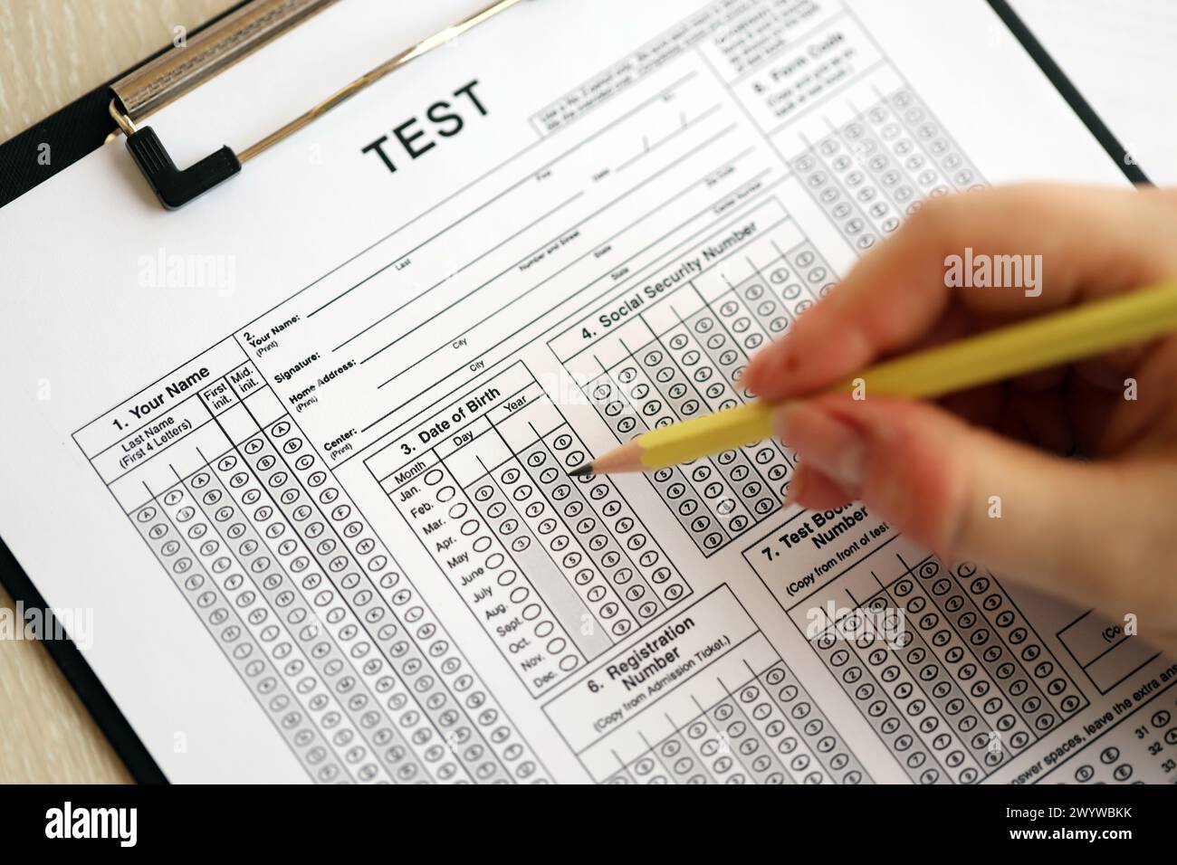 Female student hands testing in exercise and taking fill in exam paper ...