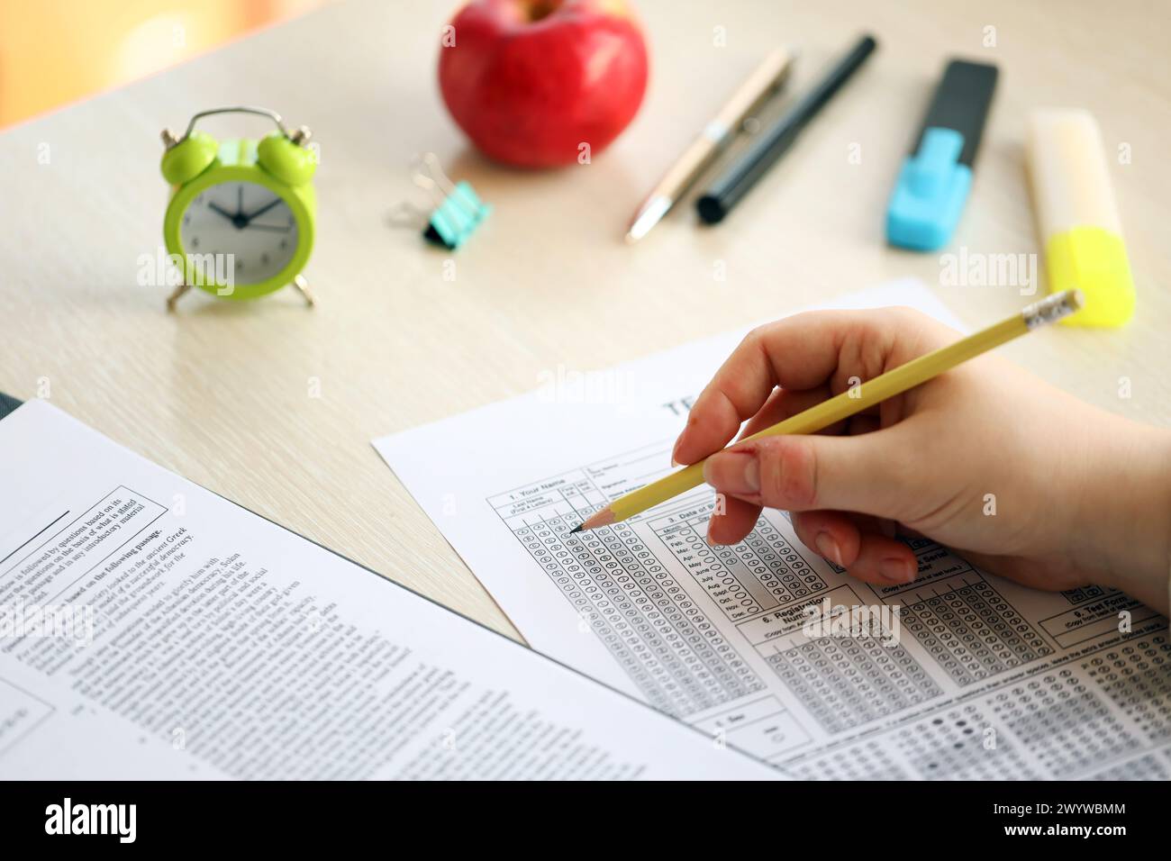 Female student hands testing in exercise and taking fill in exam paper ...