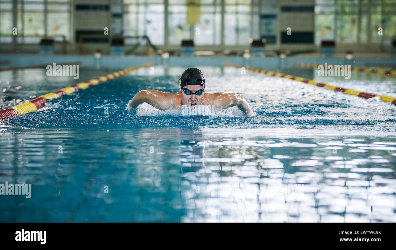 Successful professional female swimmer swimming butterfly stroke in the ...