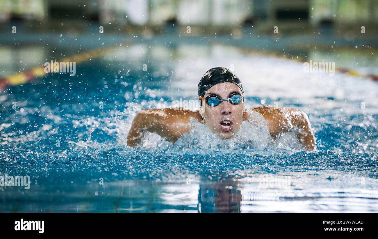 Front view of a female swimmer swimming butterfly style, a stroke ...