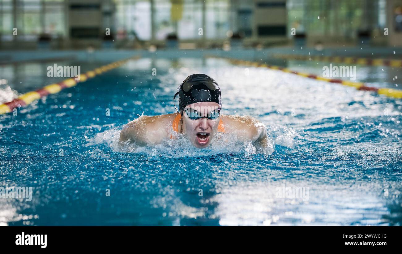 Successful professional female swimmer swimming butterfly stroke in the ...