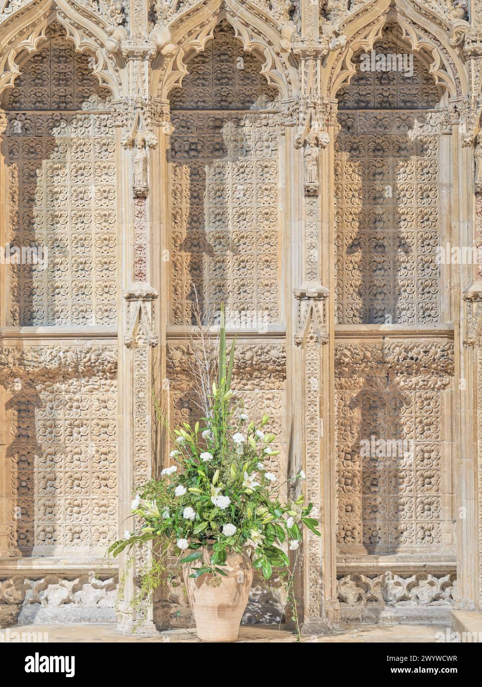 A pot of white lilly flowers, symbol of easter, in front of the ...