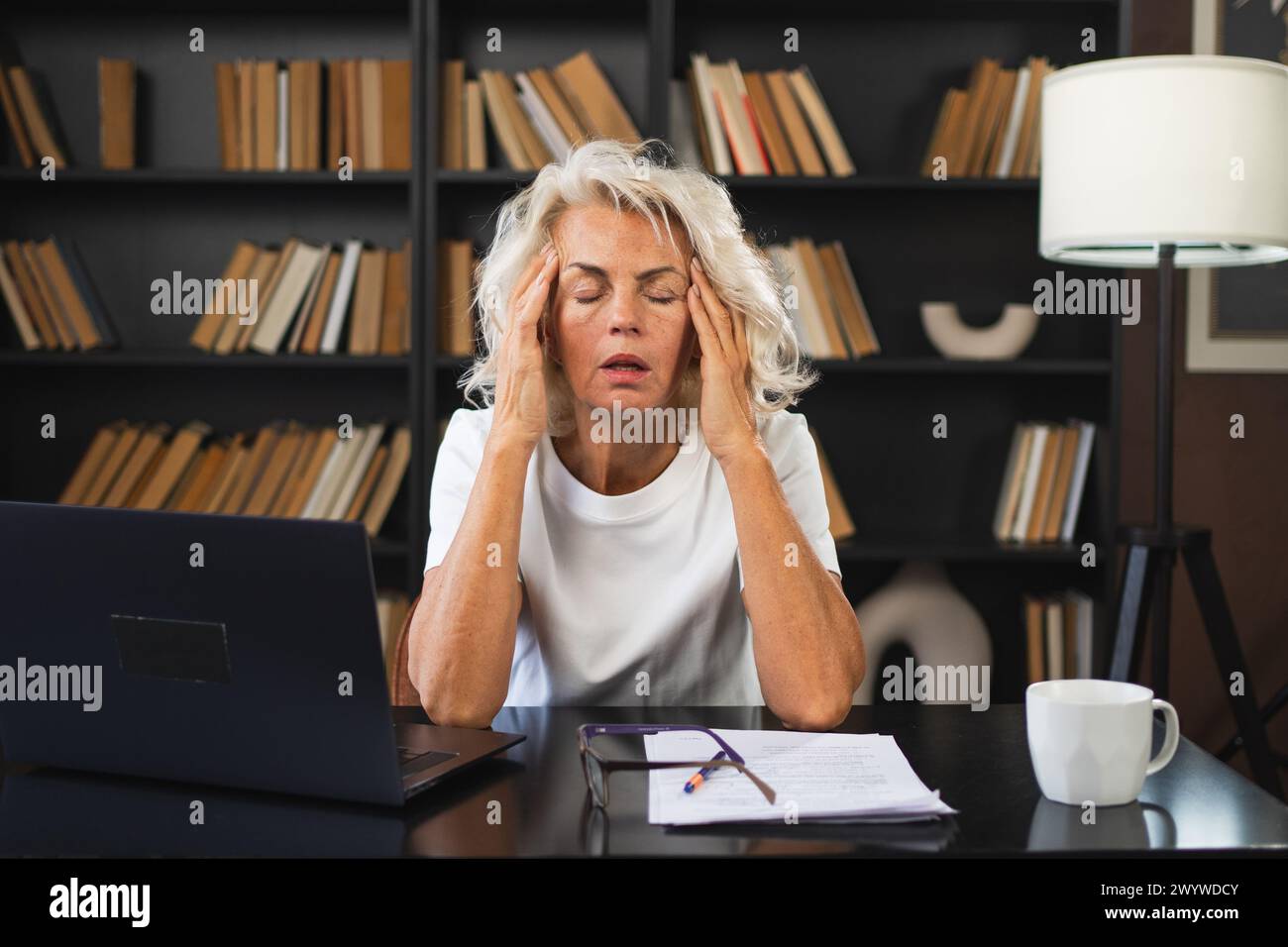 Headache pain. Middle aged woman touching temples experiencing stress ...
