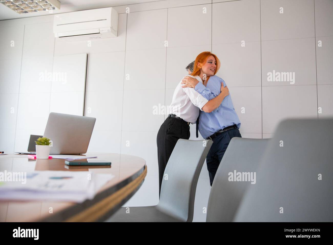 Two business people hug each other after reaching an agreement Stock ...