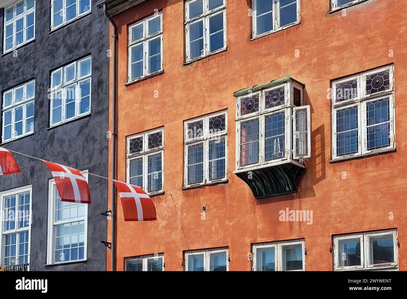 Danish flag and old windows on a colorful building in Copenhagen ...