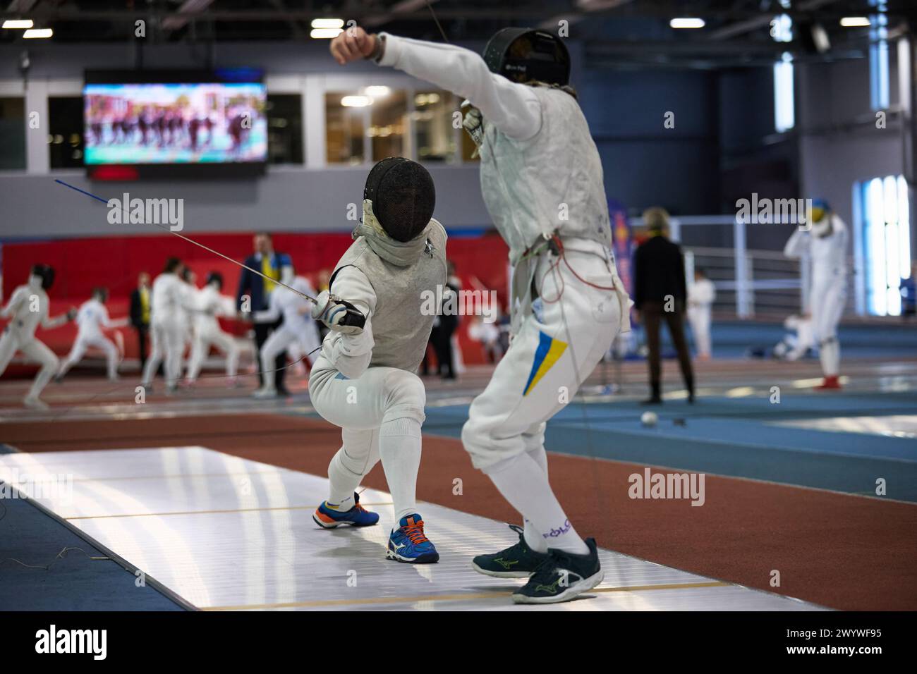 Fencers fighting on the fencing track. National Fencing Championship of ...