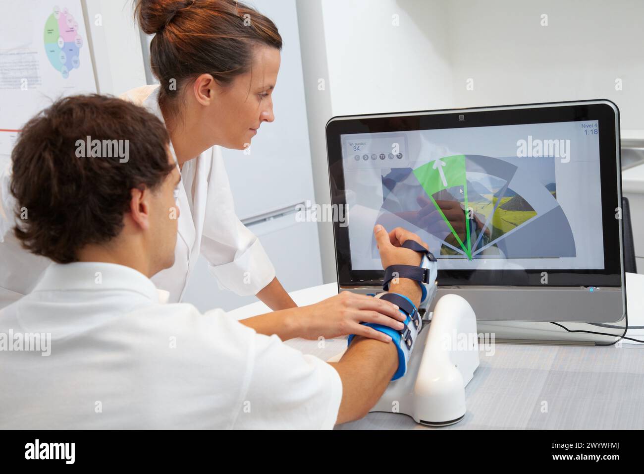 Investigator and patient with assistive robot for upper limb ...