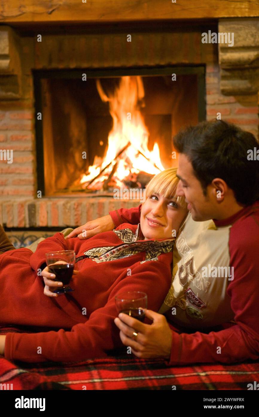 Sitting couple leaning fireplace hi-res stock photography and images ...