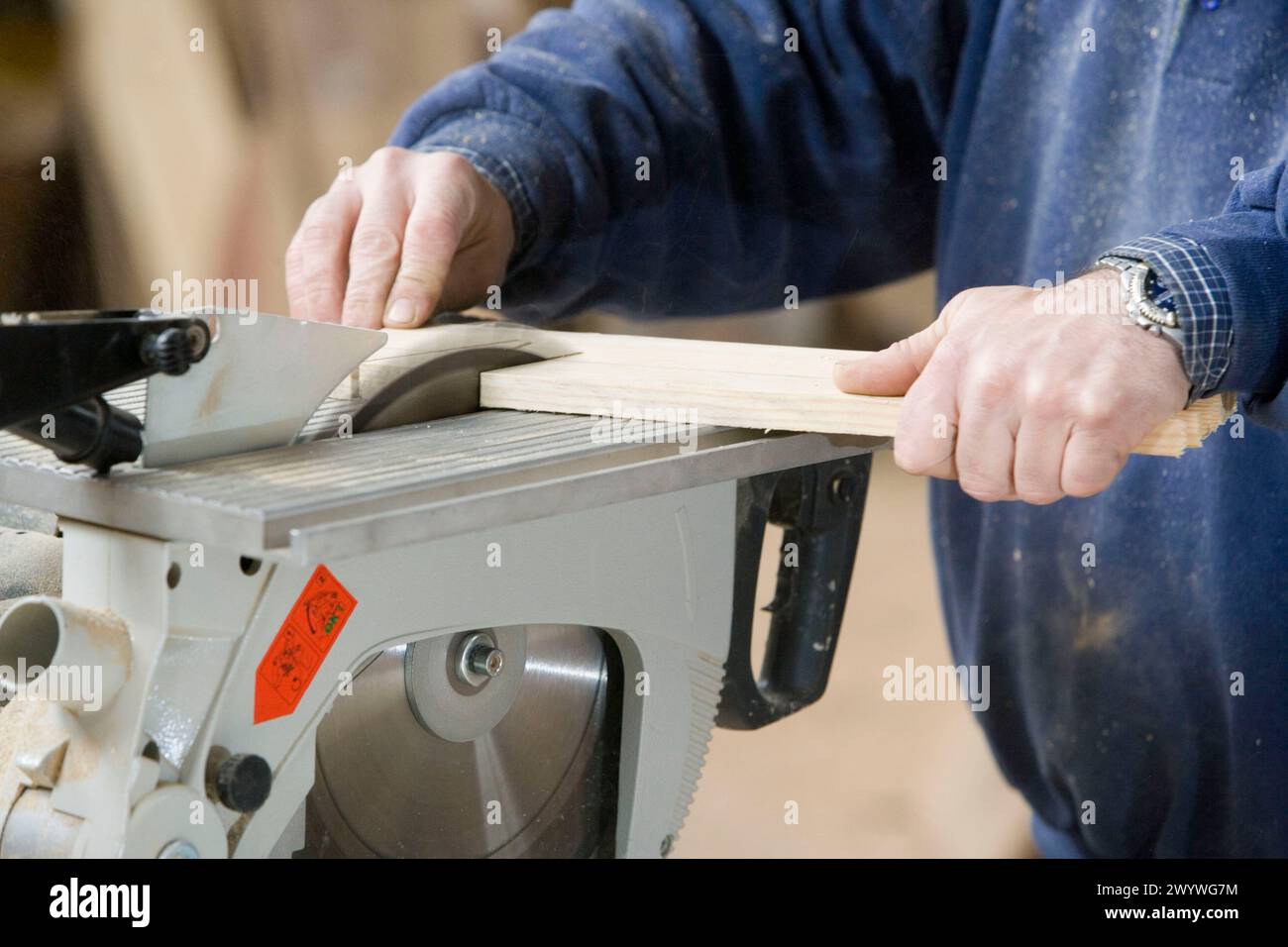 Carpenter cutting wood with electrical saw. Wood carpentry Stock Photo ...