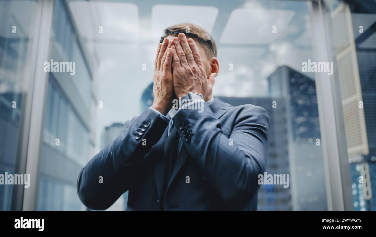 Stressed Out Manager Going Down from Office in a Glass Elevator in ...