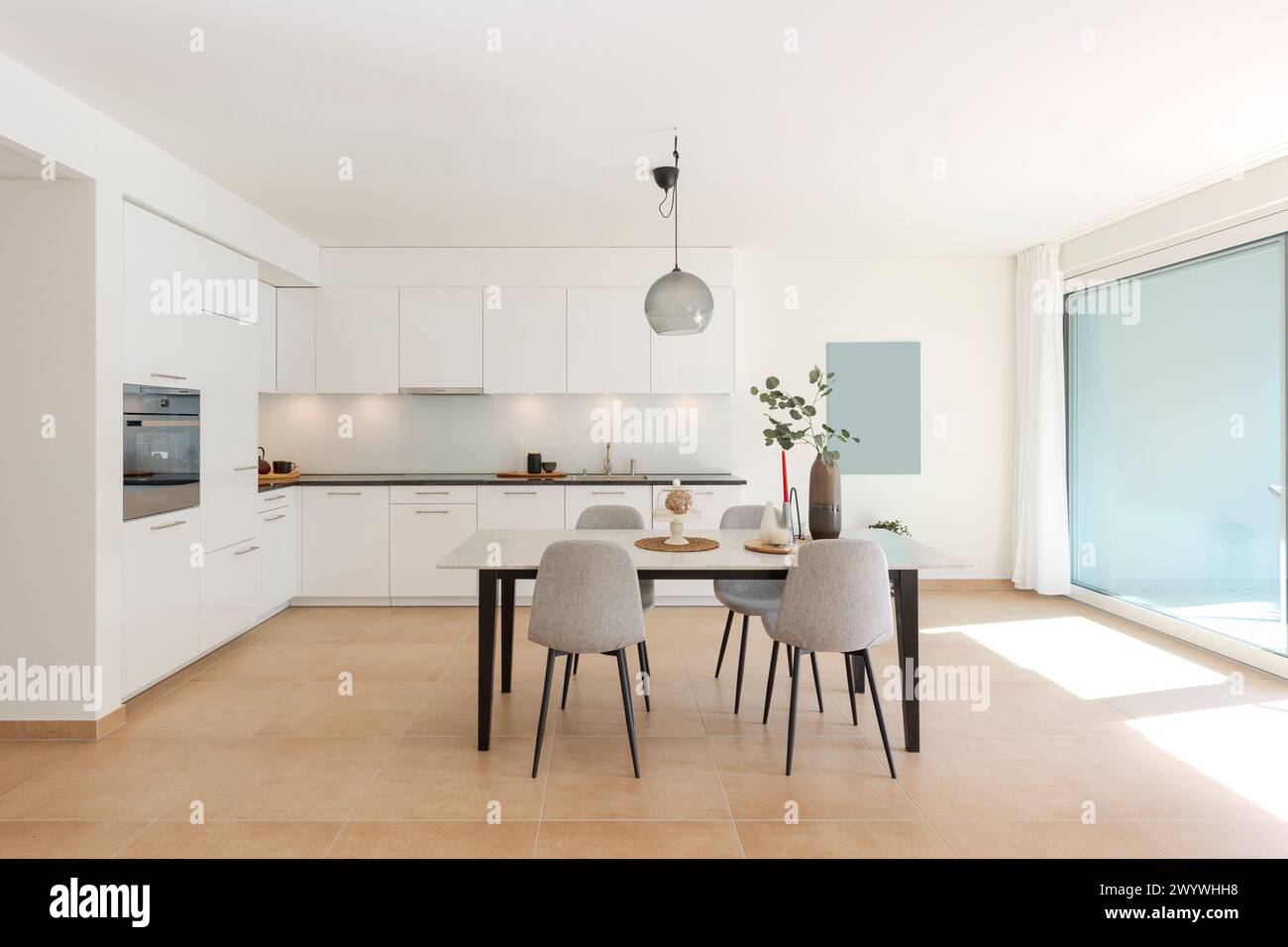 interior of modern furnished flat with open kitchen and large dining ...