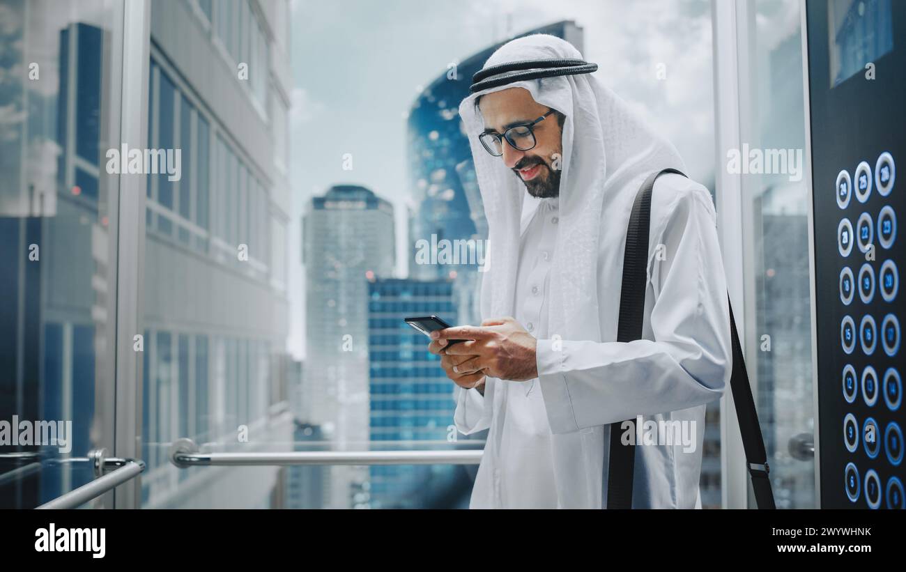 Successful Muslim Businessman in Traditional White Kandura Riding Glass ...