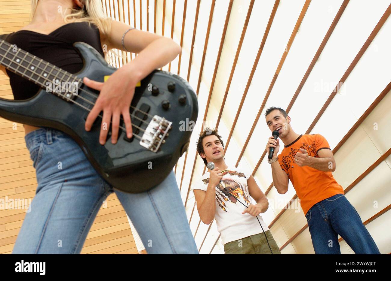 Three teens playing music and singing hi-res stock photography and ...